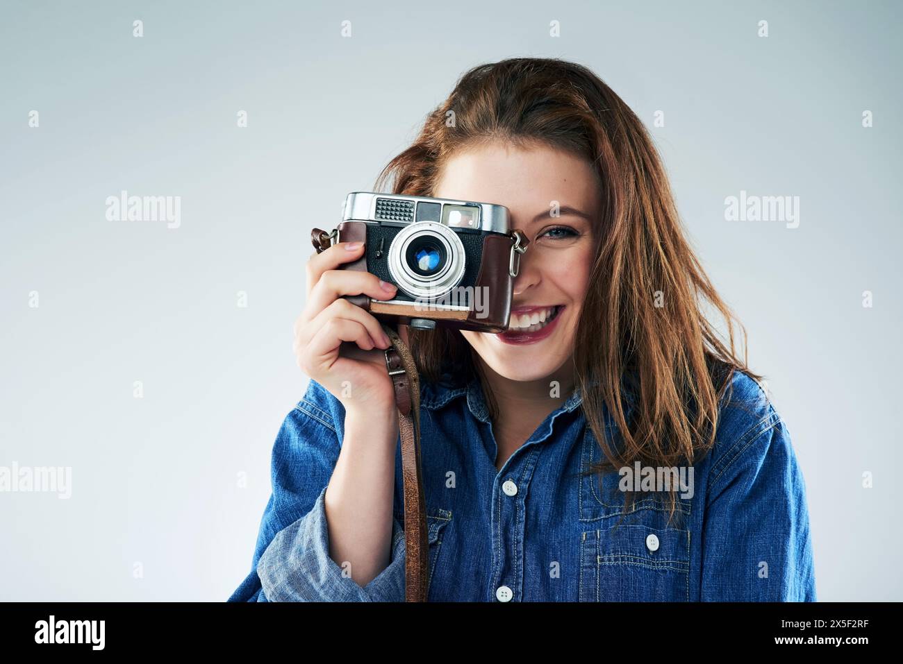 Woman, portrait and vintage camera in studio for newspaper, magazine ...