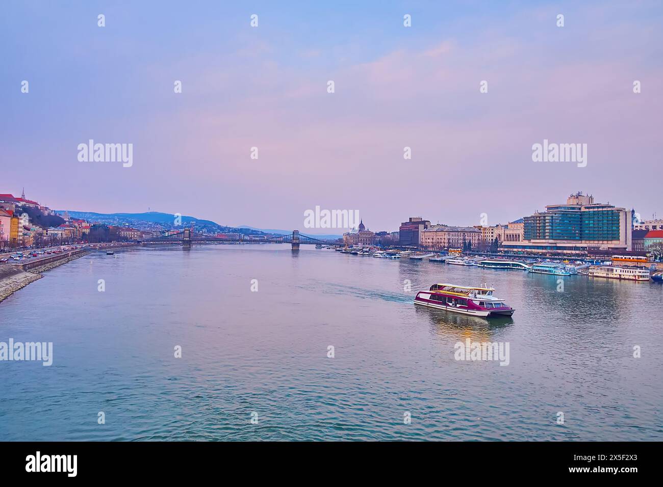 The evening cityscape with purple waters of Danube, Szechenyi Chain ...