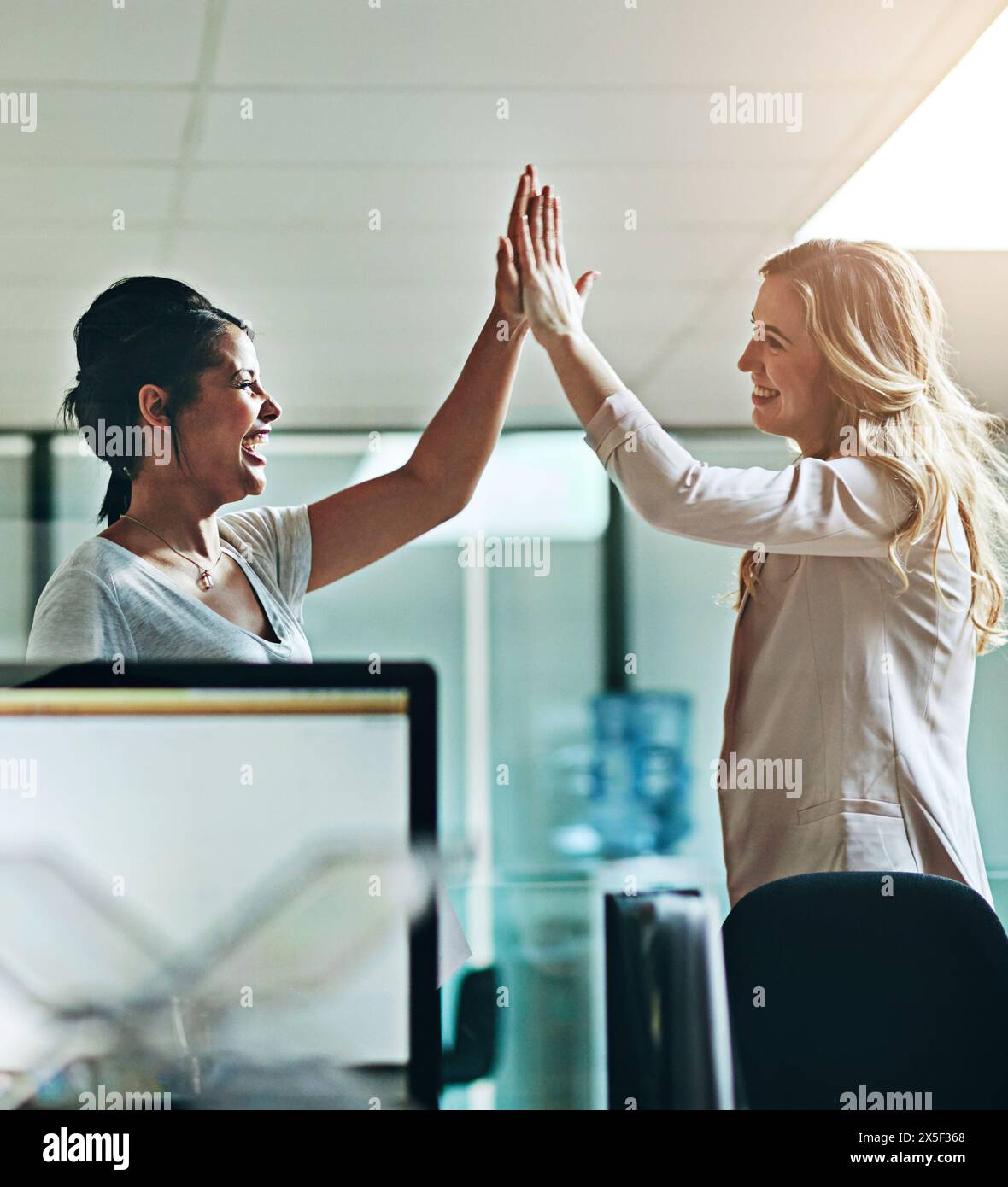 Teamwork, support and happy colleagues sharing high five in a modern ...