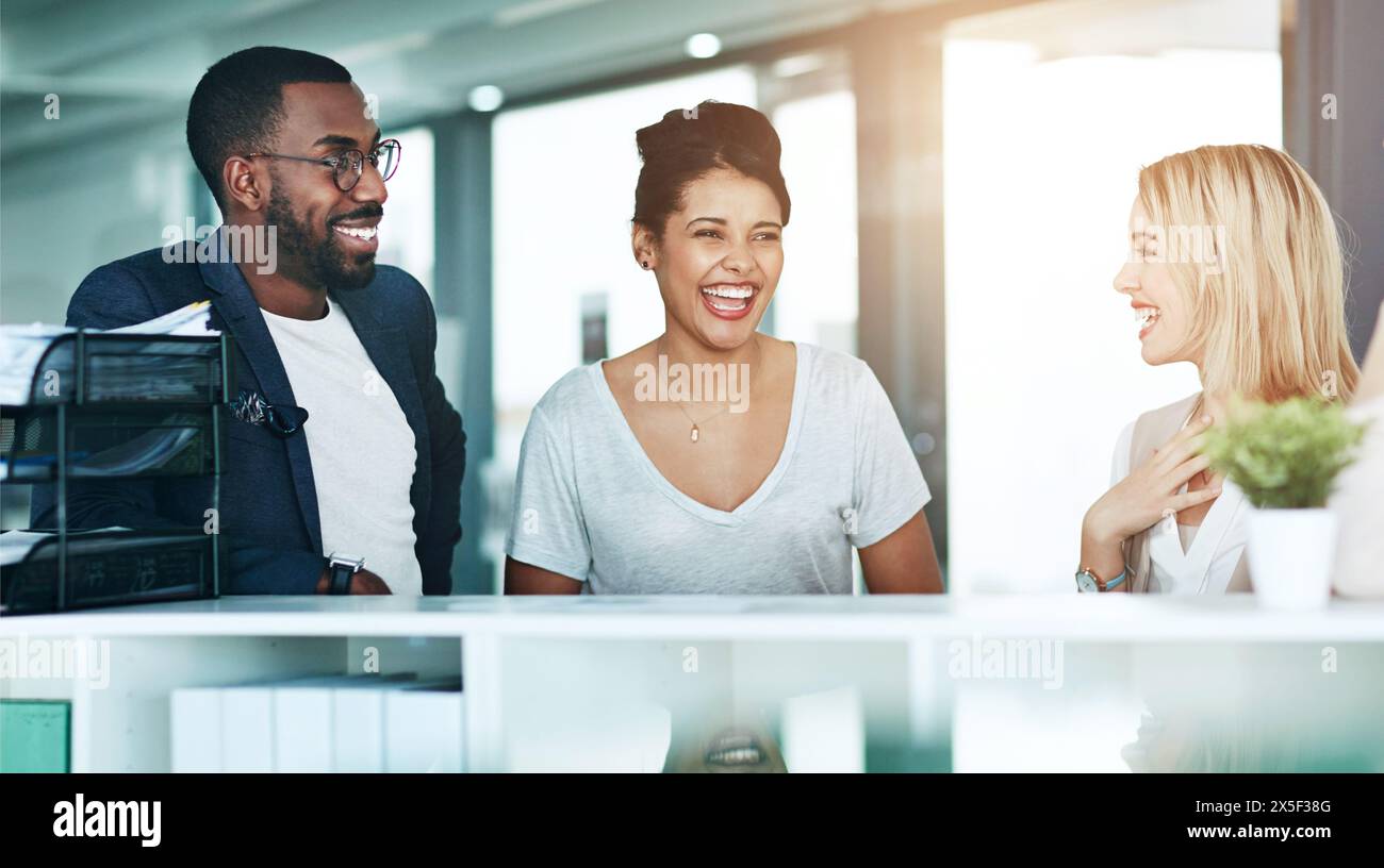 Business people, happy and discussion by front desk in office with ...