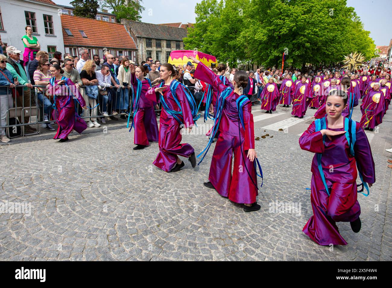 A group of volunteers in colourful attire during the Holy Blood ...