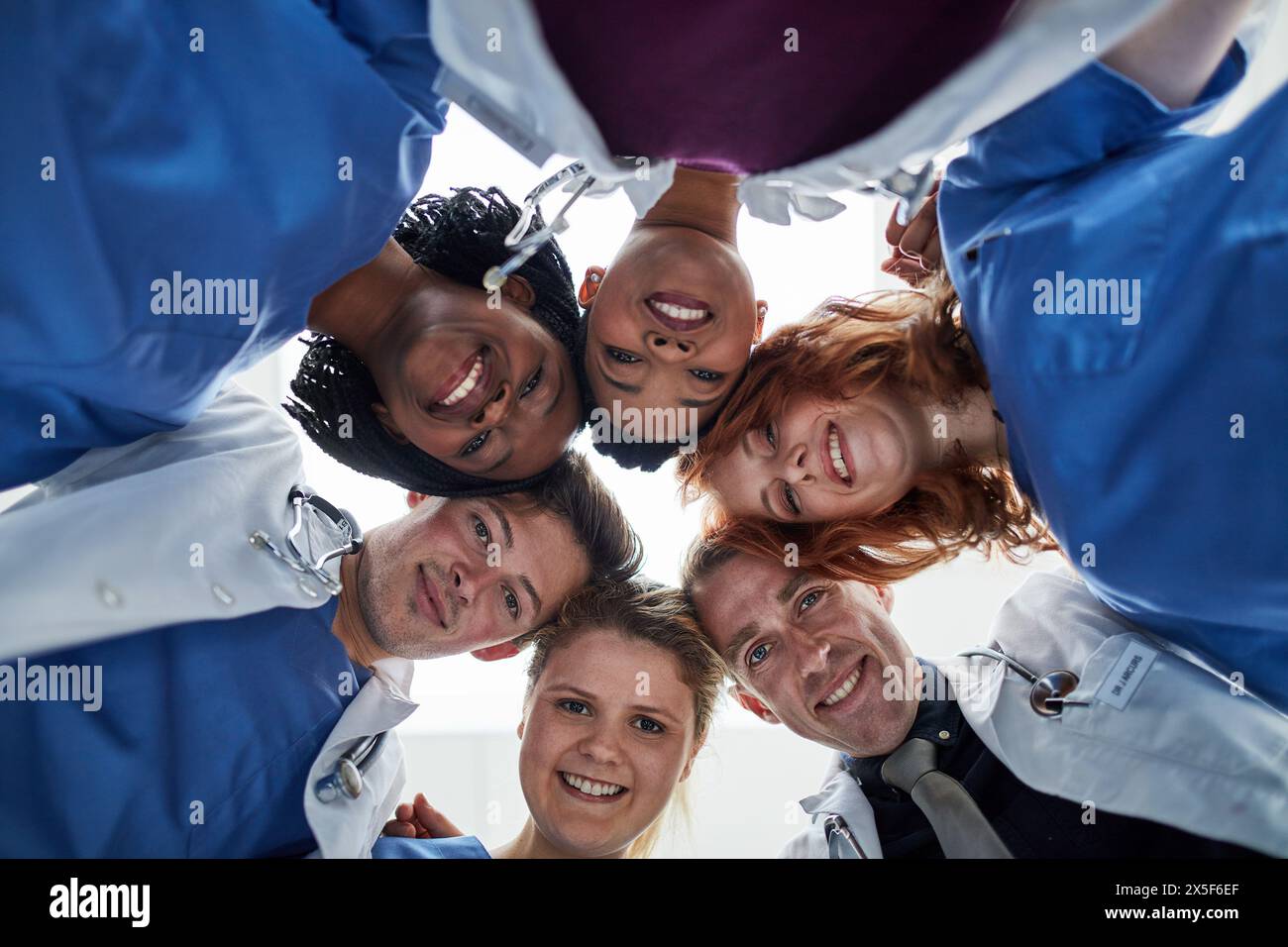 Portrait, teamwork or doctors in huddle with support in collaboration for healthcare mission ...