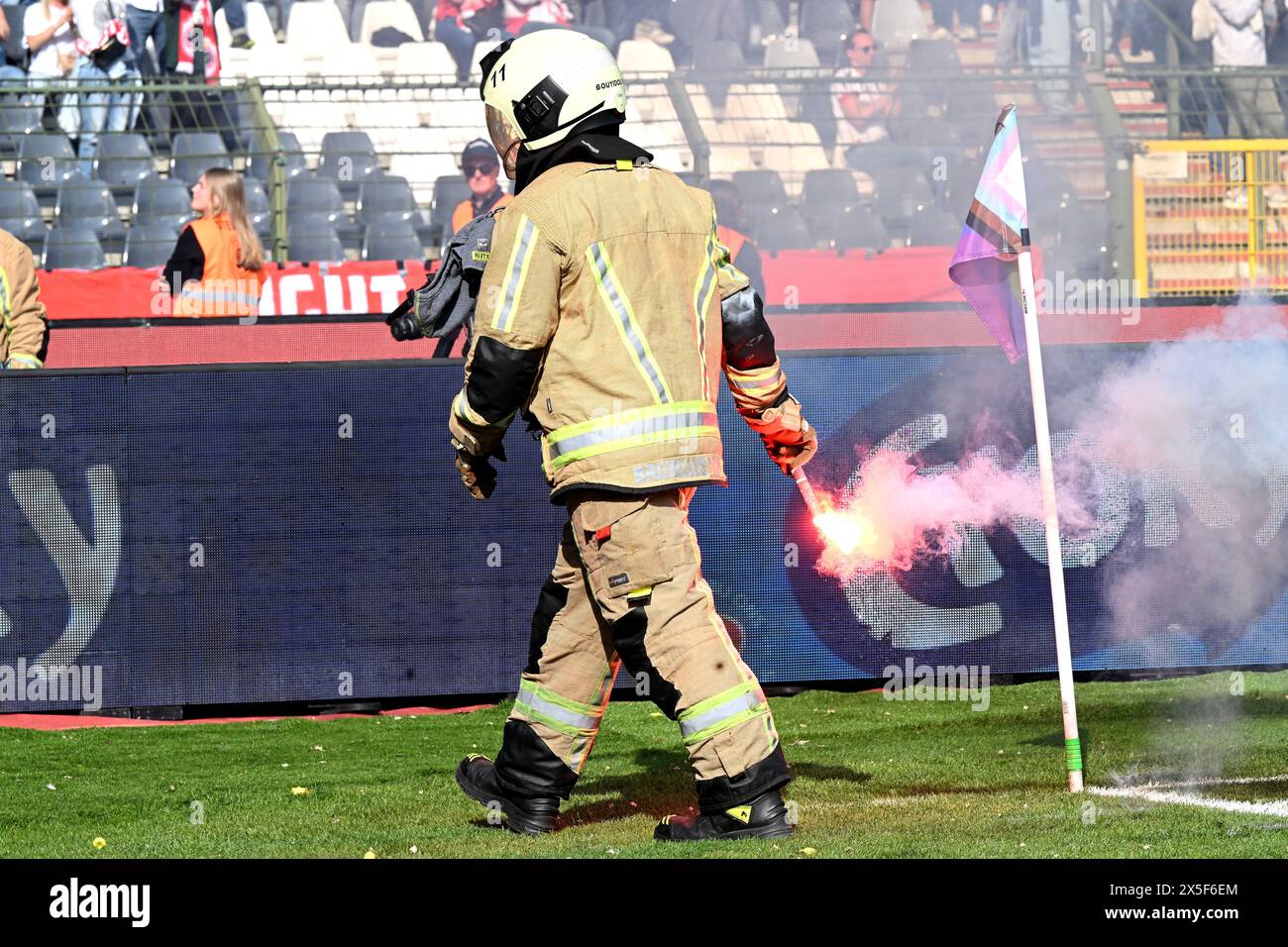 BRUSSELS - Firefighter removes fireworks from the field after the ...