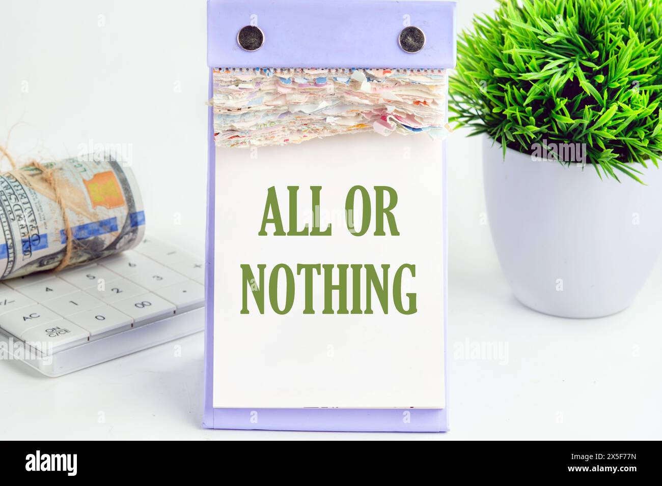 All or nothing, motivational phrase It is written on a piece of desktop ...