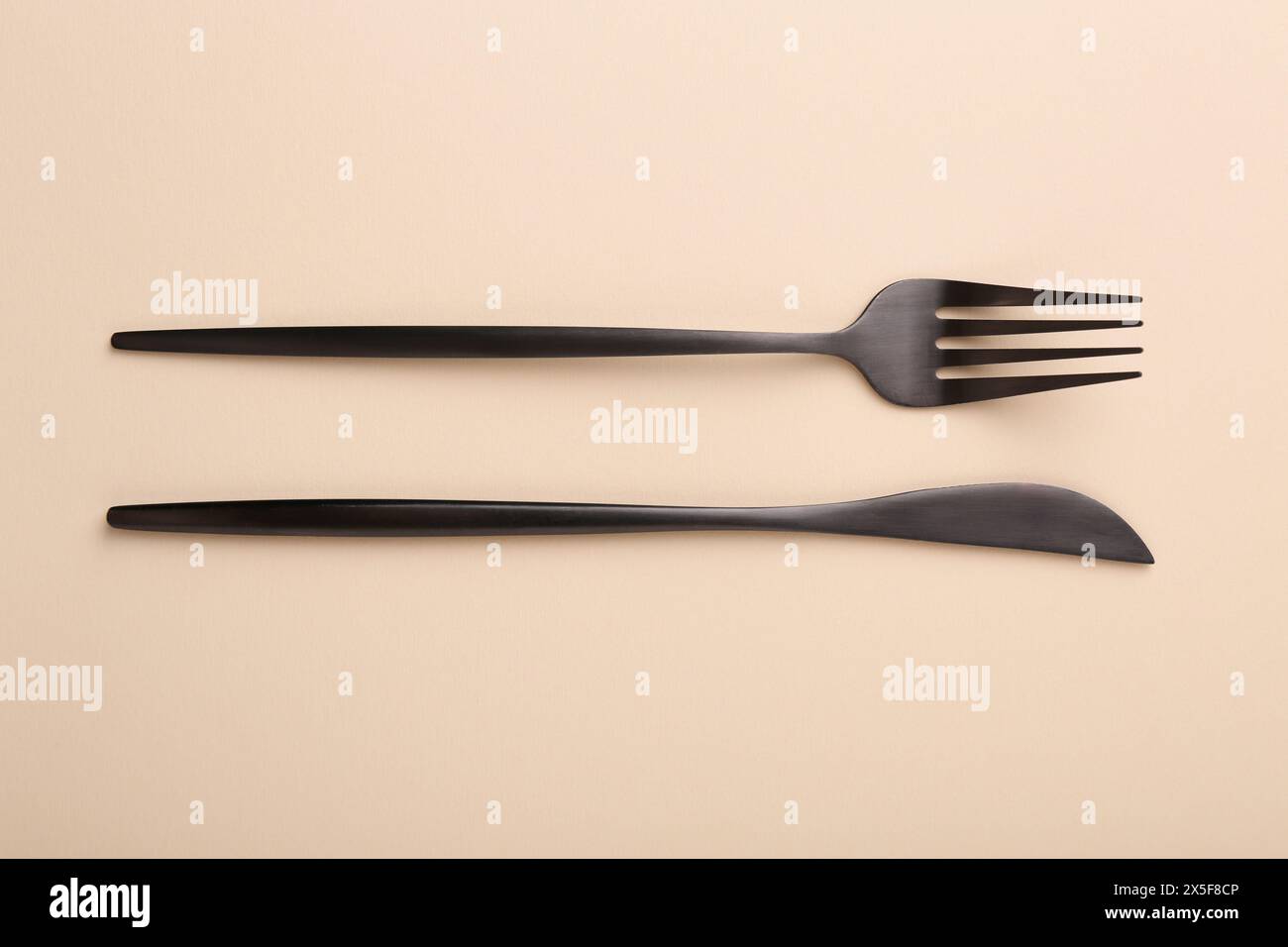 Stylish cutlery on beige table, top view Stock Photo - Alamy