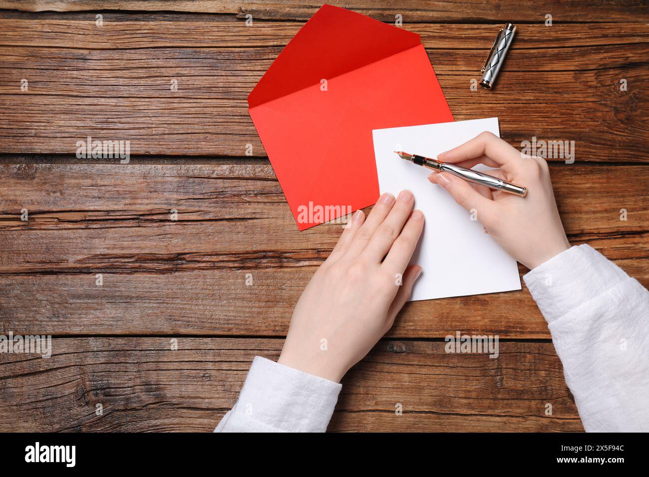 Woman writing letter at wooden table, top view. Space for text Stock ...