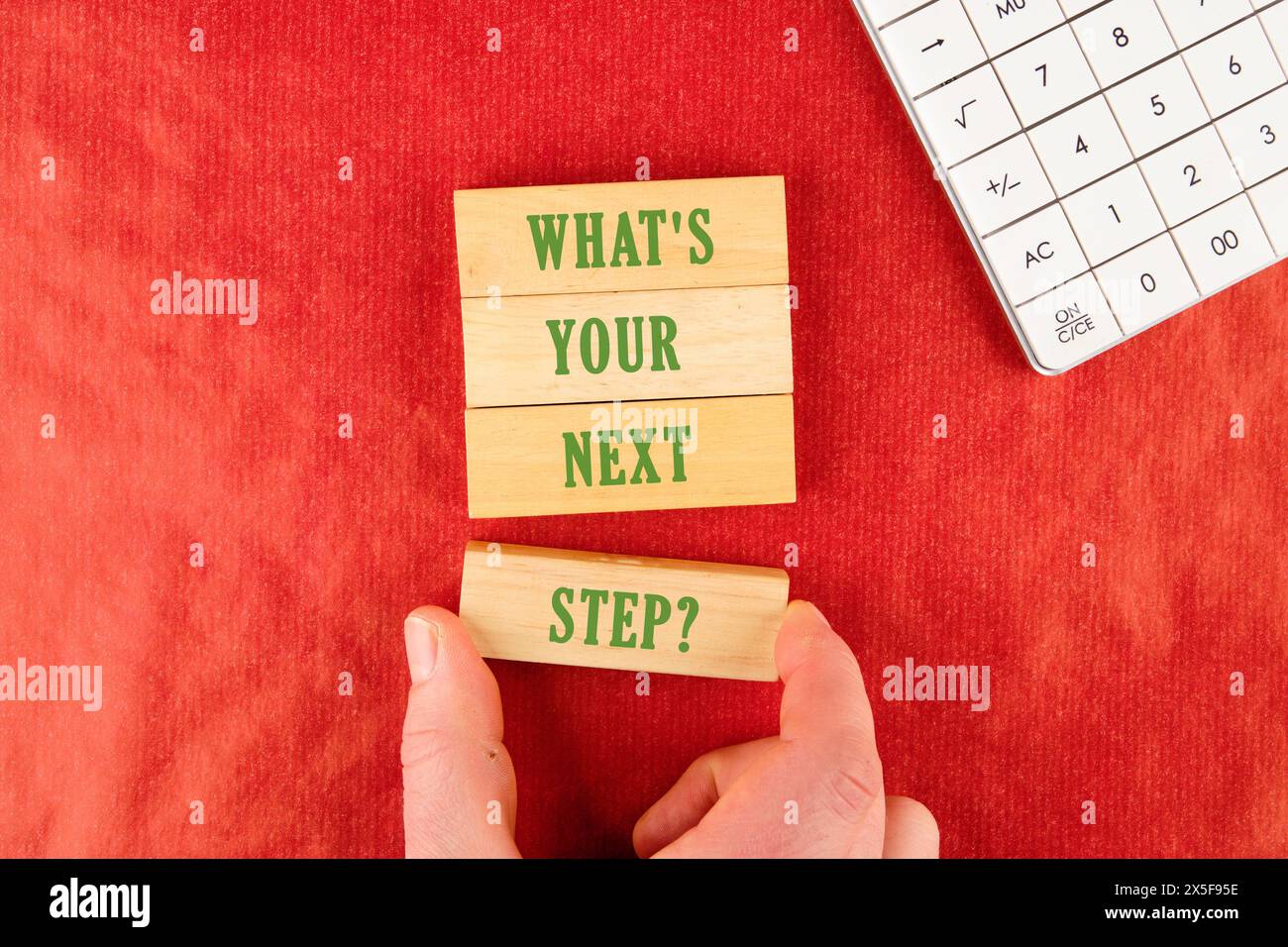 What is your next step symbol text is made up of wooden blocks on a red ...