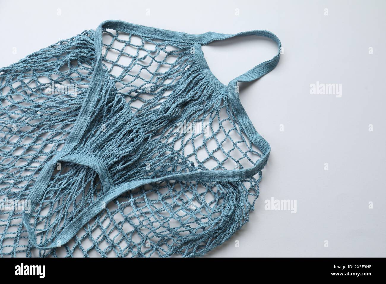Blue string bag on light grey background, top view Stock Photo - Alamy