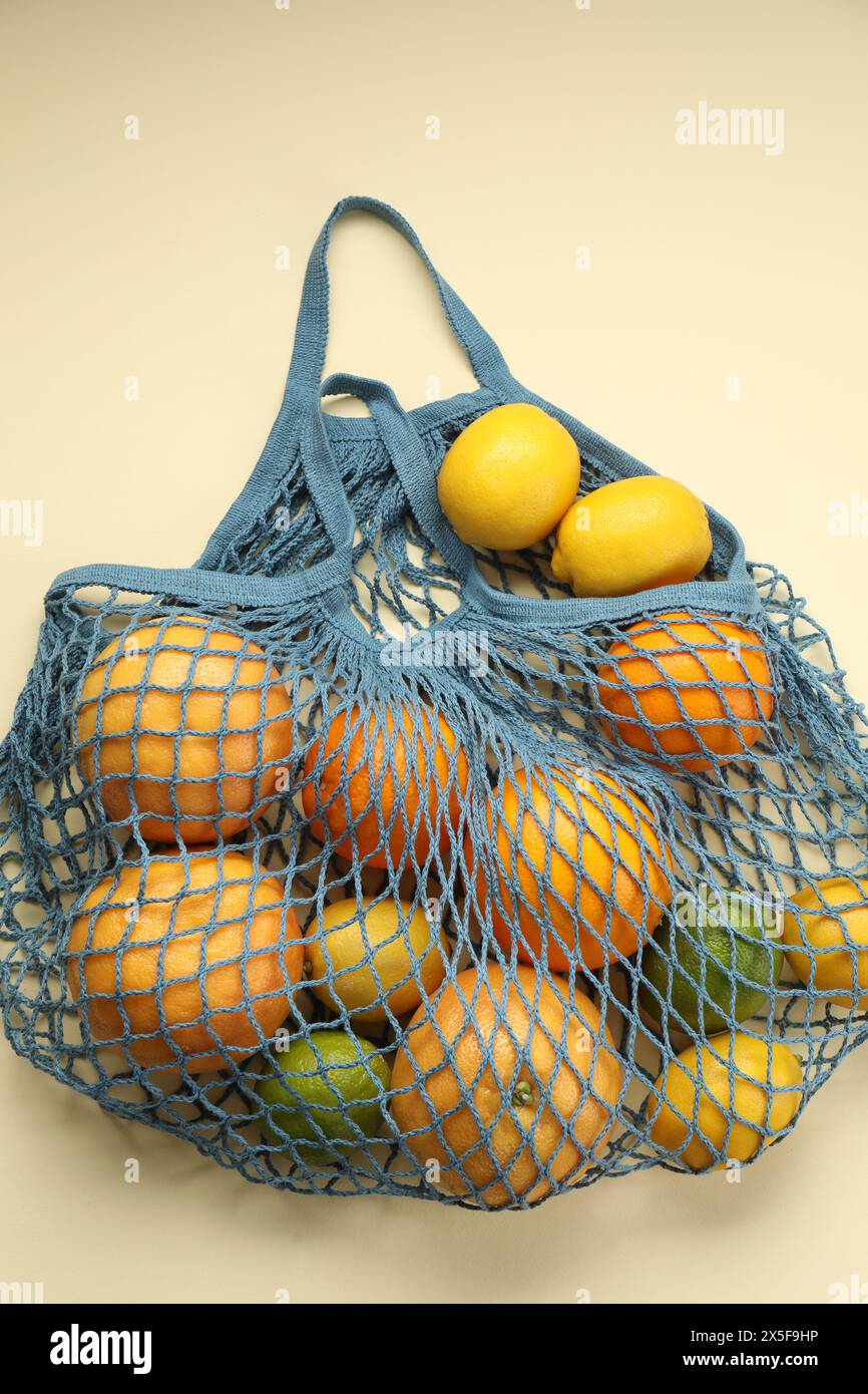 String bag with different fruits on beige background, top view Stock ...
