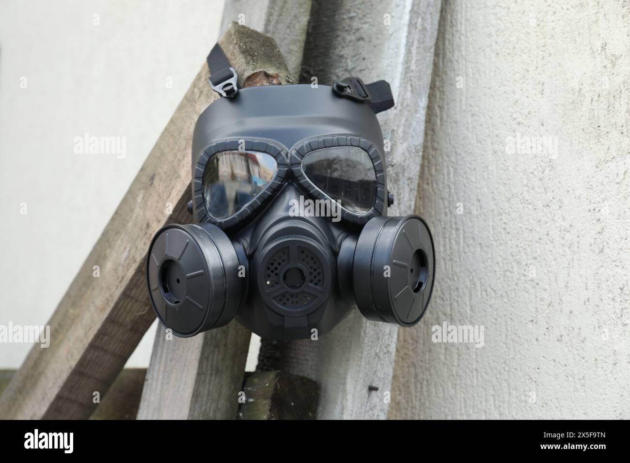 One gas mask hanging on building outdoors. Safety equipment Stock Photo ...