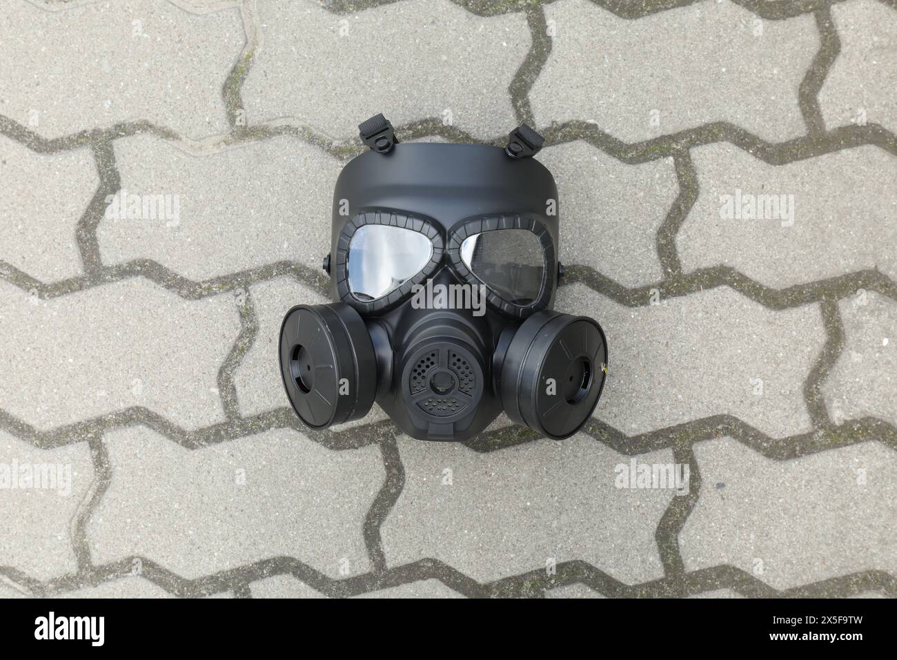 One gas mask on paved pathway outdoors, top view Stock Photo - Alamy