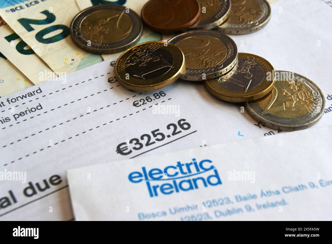 Electric Ireland electricity bill and money. Euro coins and banknotes ...