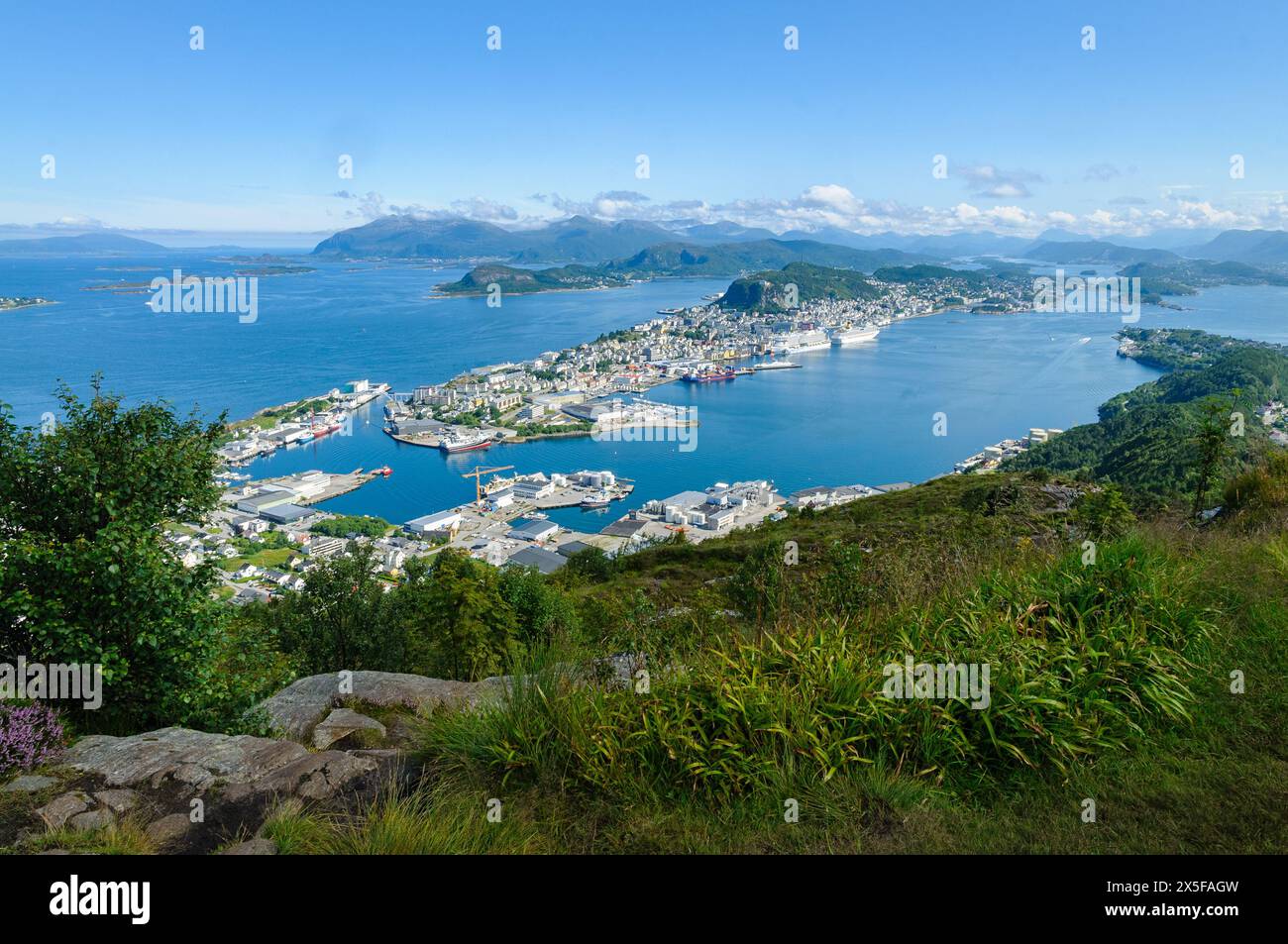 A scenic overlook captures a vibrant coastal town surrounded by lush ...