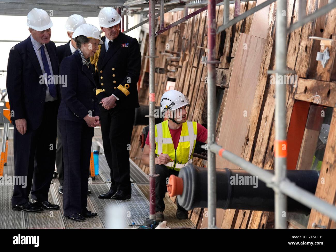 The Princess Royal (2nd left) speaks to a shipwright during a visit to ...