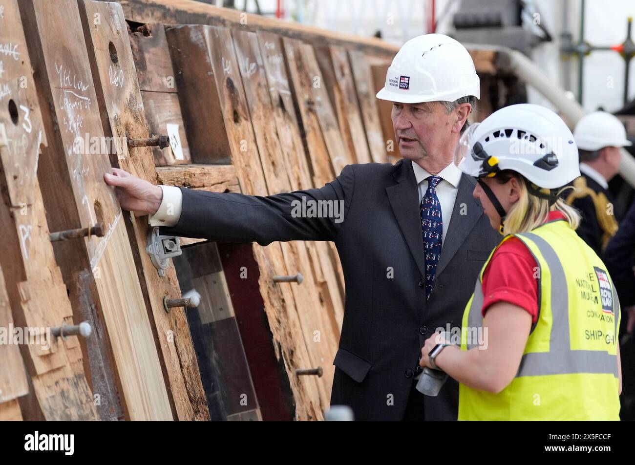 Vice Admiral Sir Tim Laurence speaks to a shipwright during a visit to see the HMS Victory ...