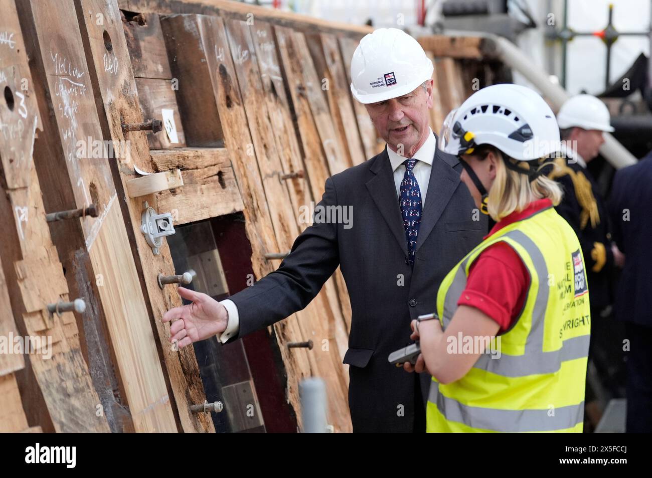 Vice Admiral Sir Tim Laurence speaks to a shipwright during a visit to see the HMS Victory ...