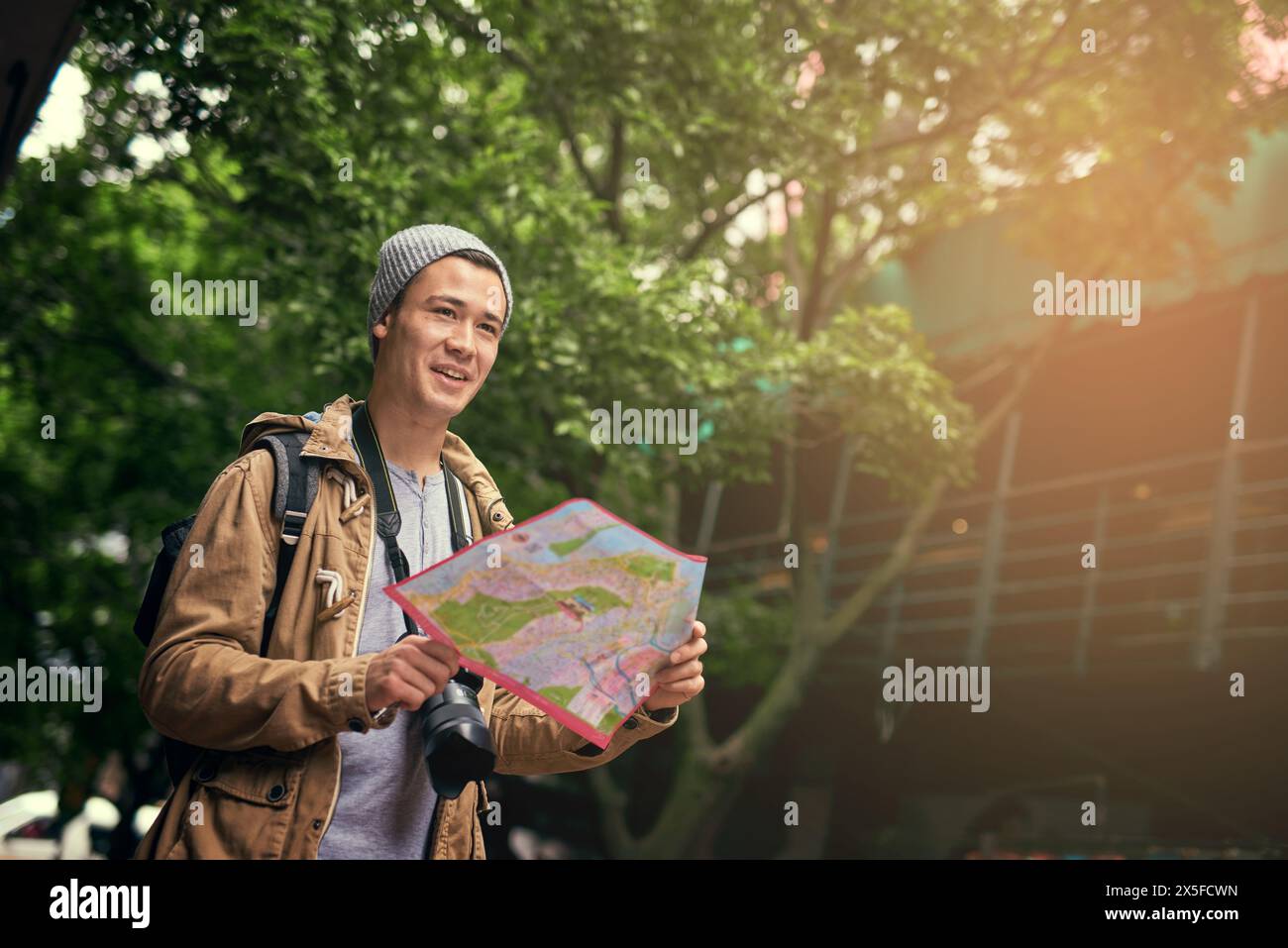 Asian man, map and city travel for directions or urban sightseeing in ...