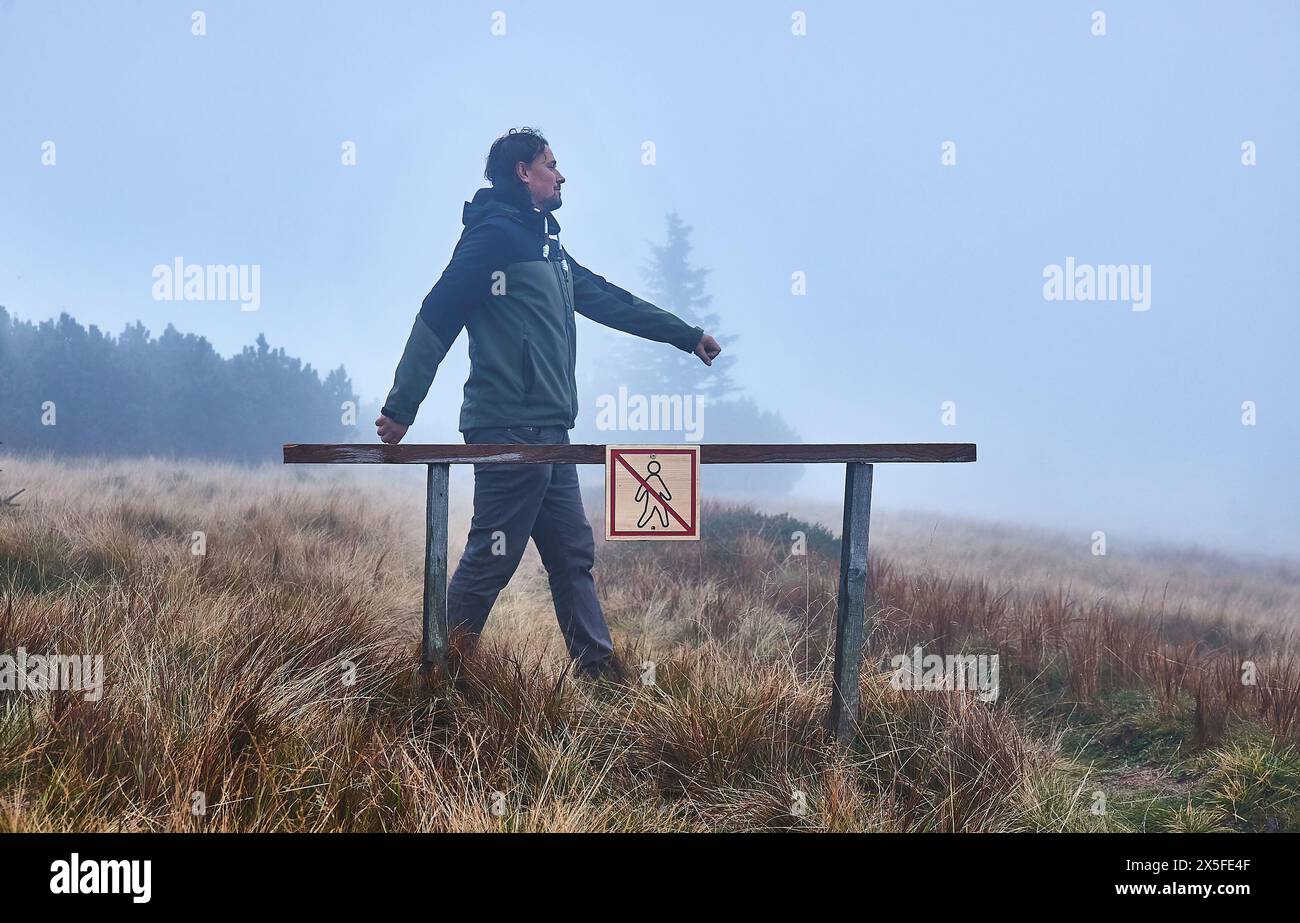 Walking past behind a no entry sign, keep out Stock Photo - Alamy