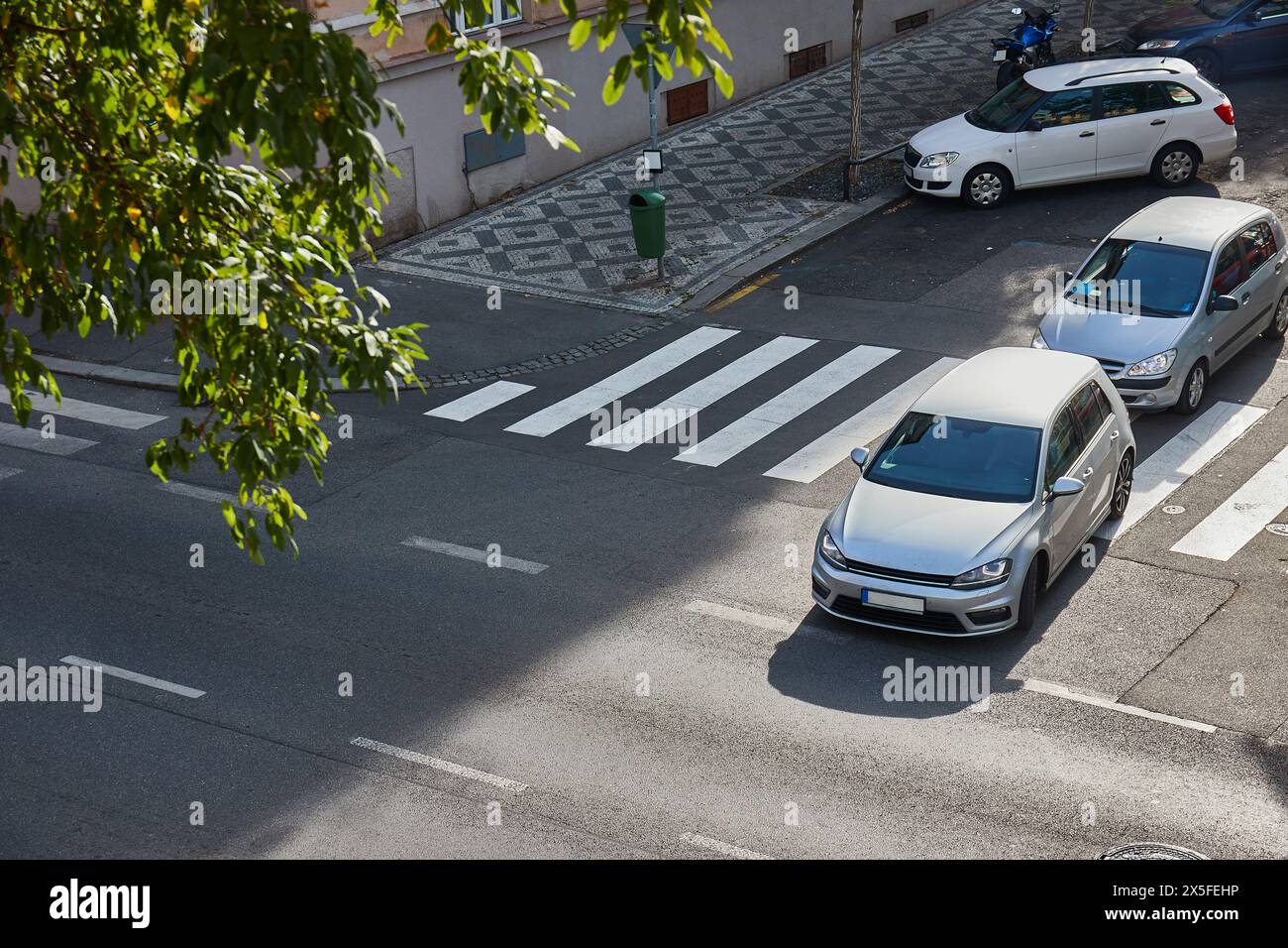 Cars on city streets turning Stock Photo - Alamy