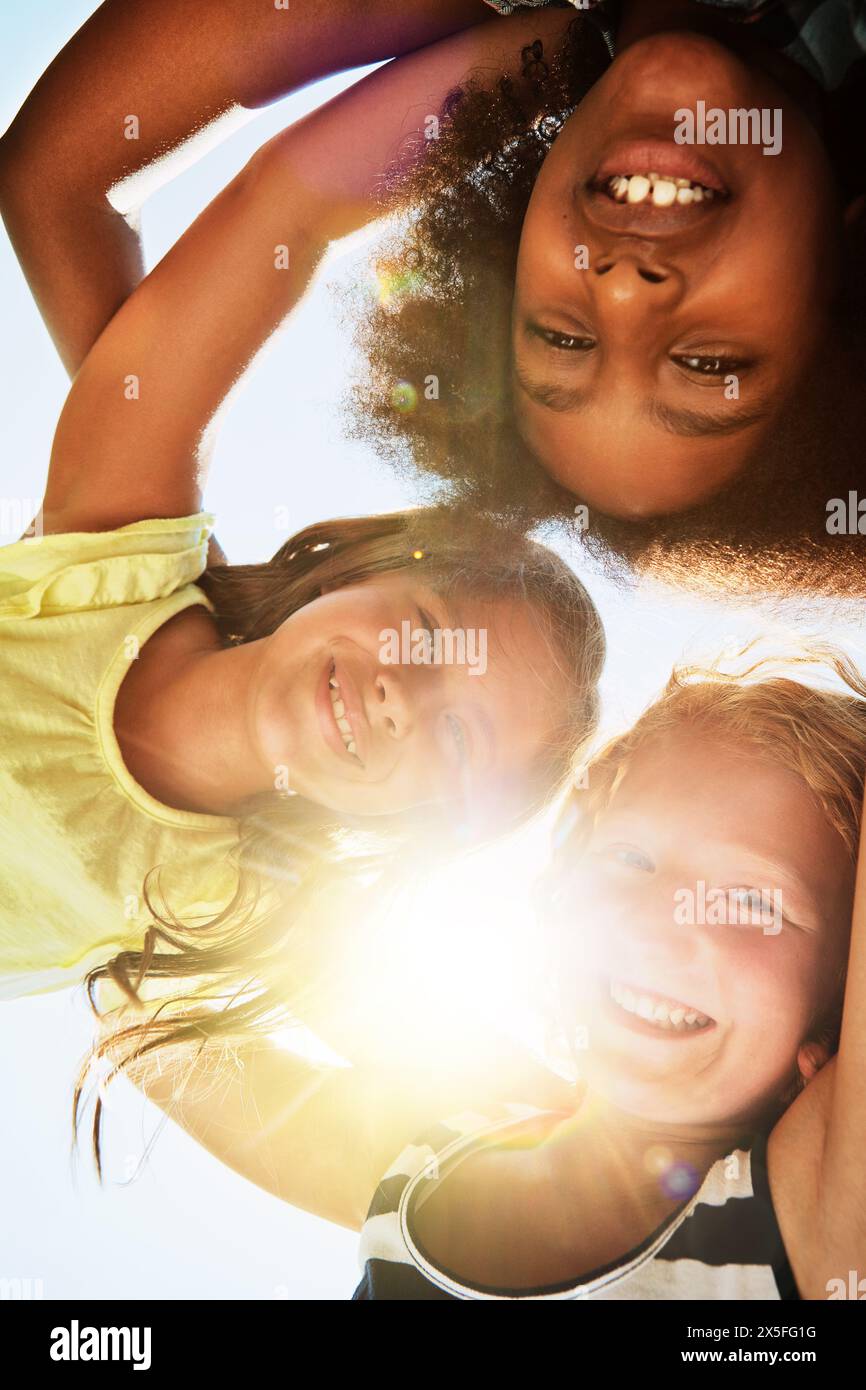 Happy, low angle and portrait of children with sunshine for friendship ...