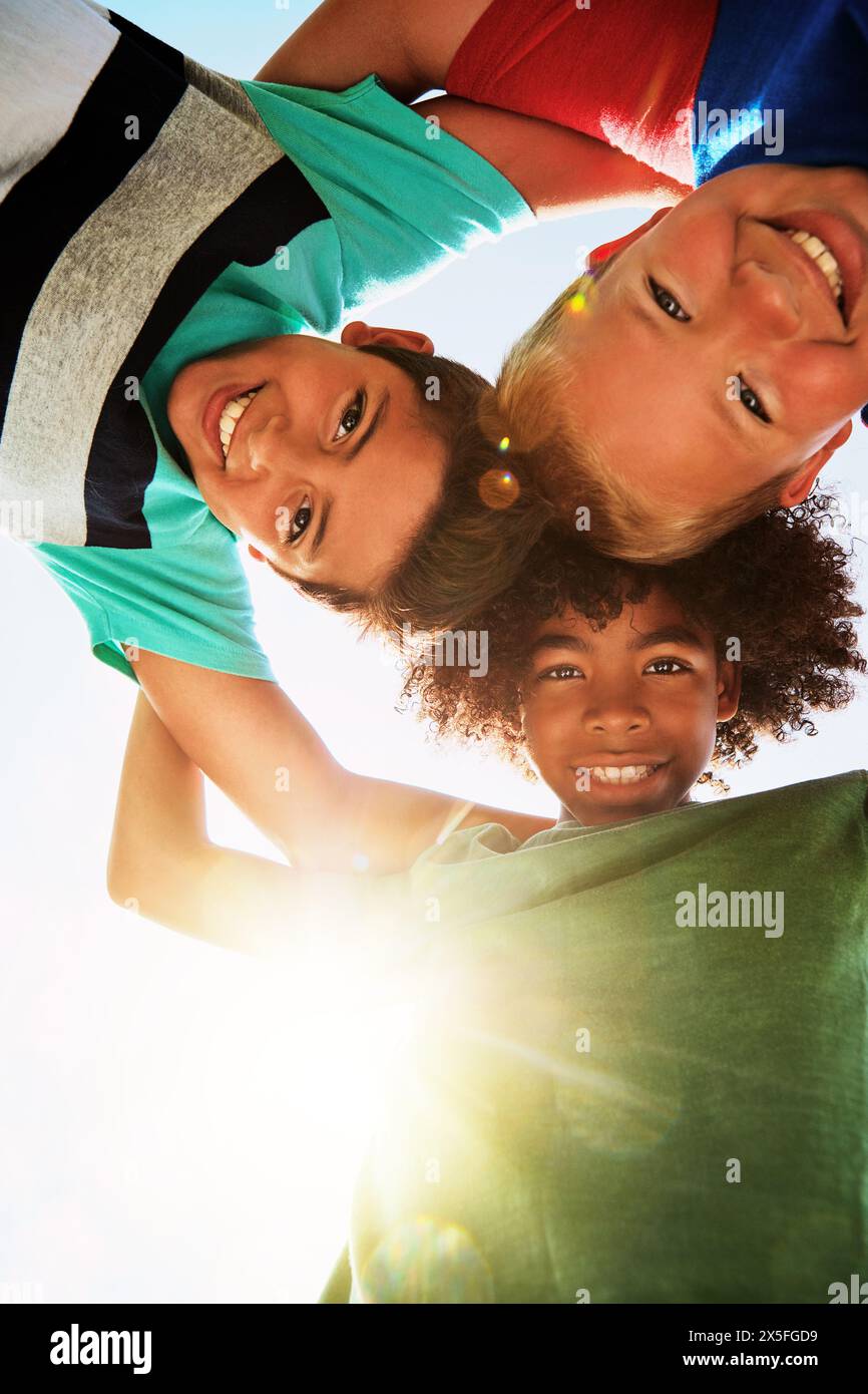 Happy, low angle and portrait of boys on camp for friendship, playing ...