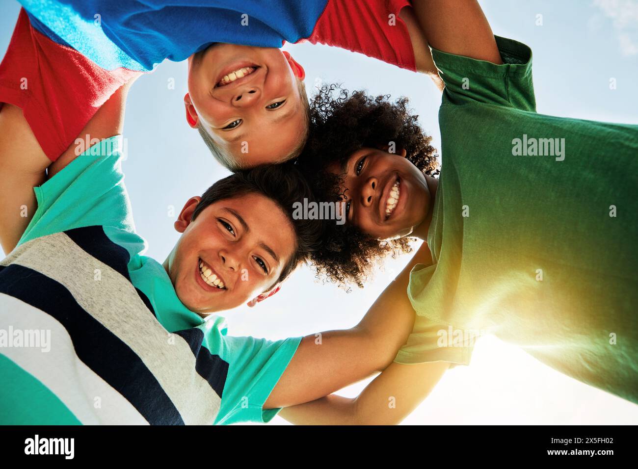 Blue sky, low angle and happy portrait of kids for friendship, playing ...