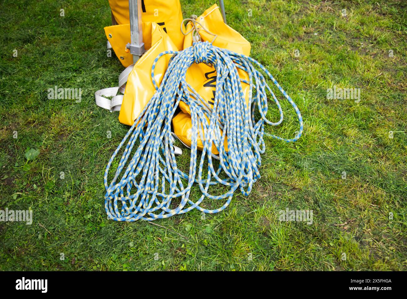 blue climbing rope on green grass . background image of the rope for ...