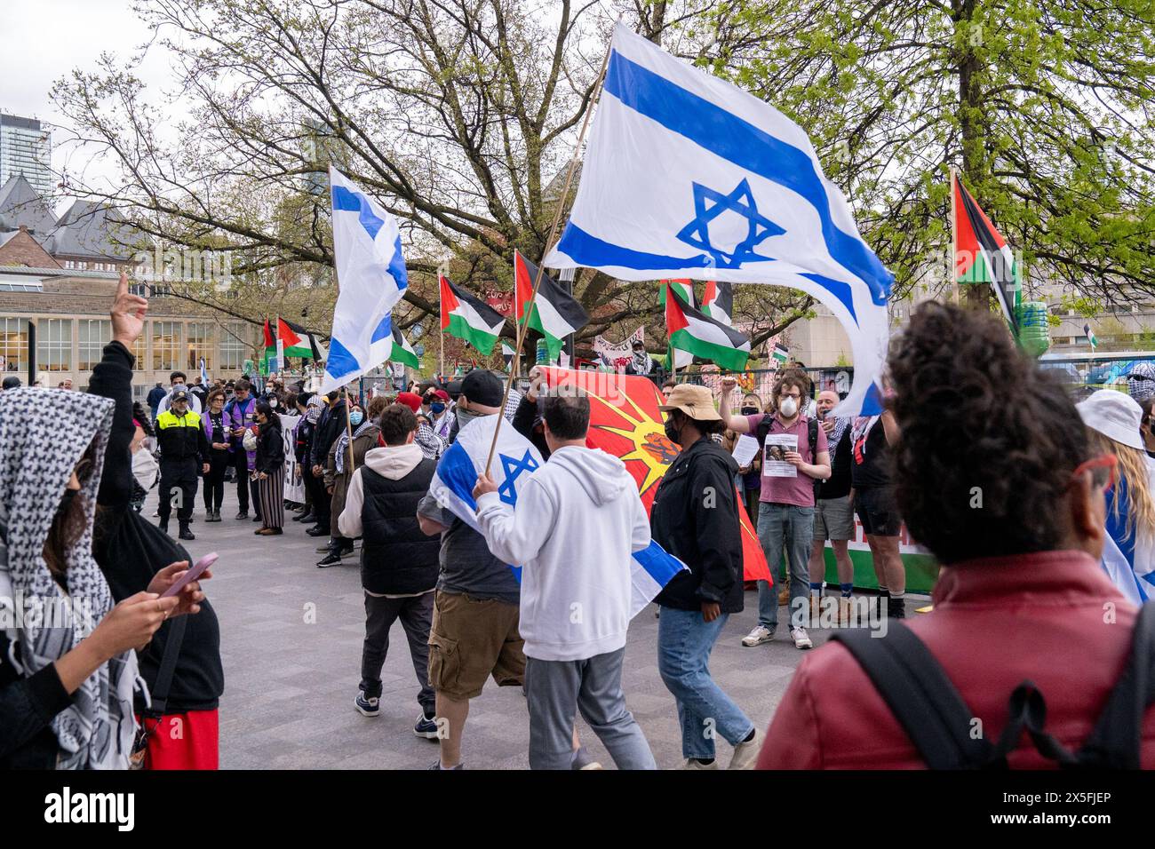 Pro-Israel supporters holding Israeli flags walks through crowd as pro ...