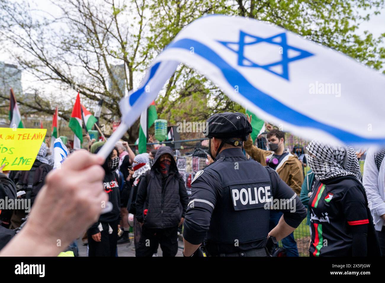 Pro-Israel supporters holding Israeli flags walks through crowd as pro ...