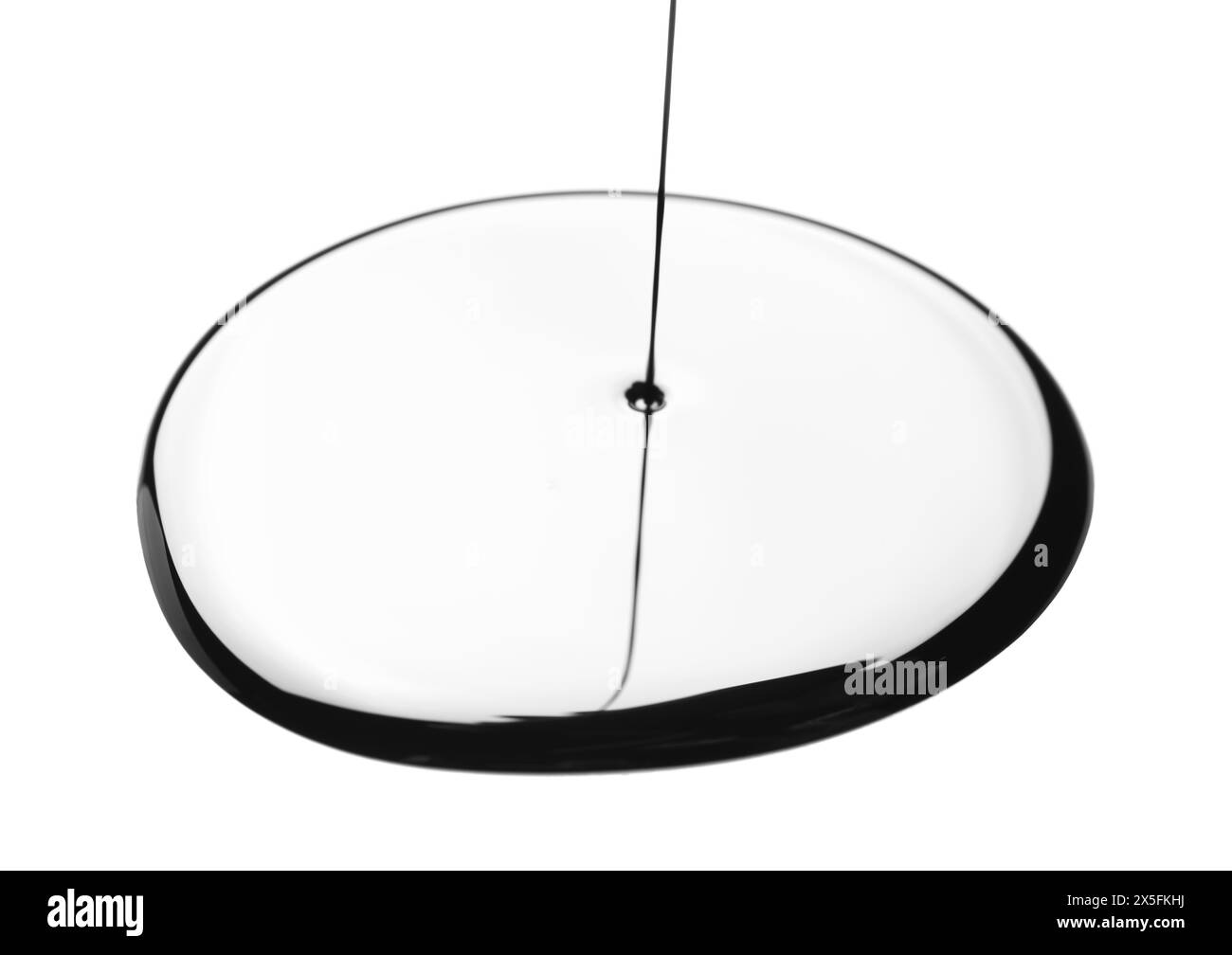 Oil pouring to puddle on white background Stock Photo - Alamy