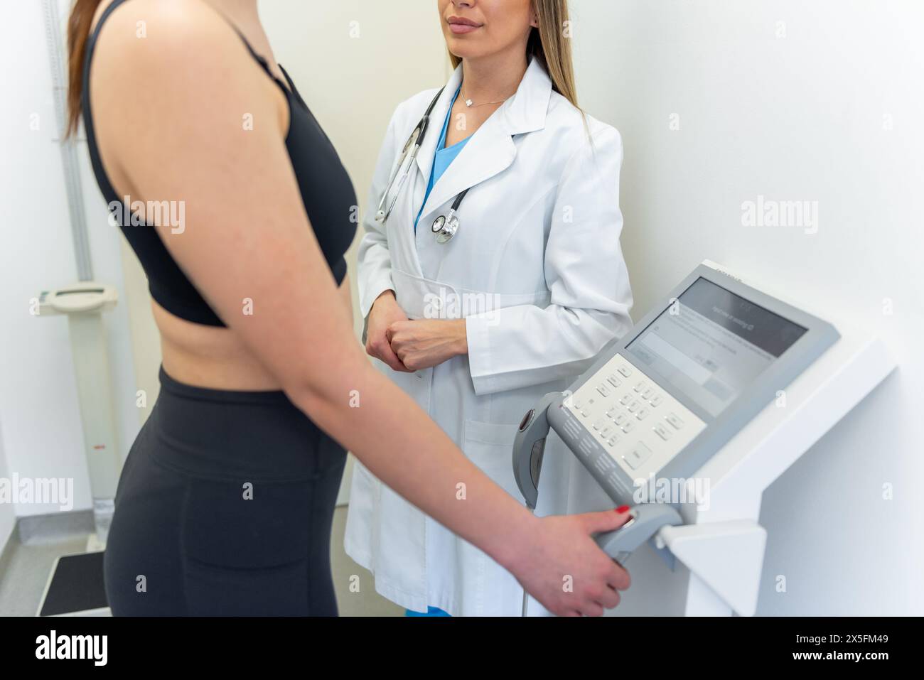 Female doctor measuring patient’s body composition with advanced ...