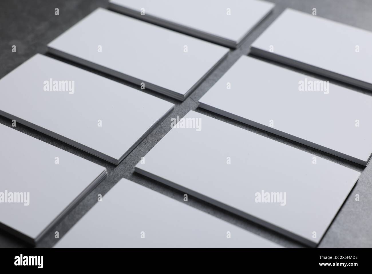 Blank business cards on grey textured table, closeup. Mockup for design ...