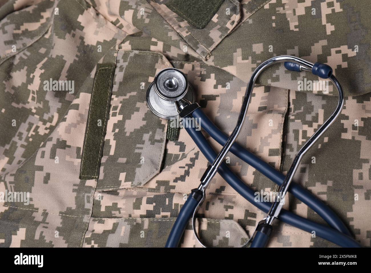 Stethoscope on soldier uniform, top view. Military service Stock Photo ...