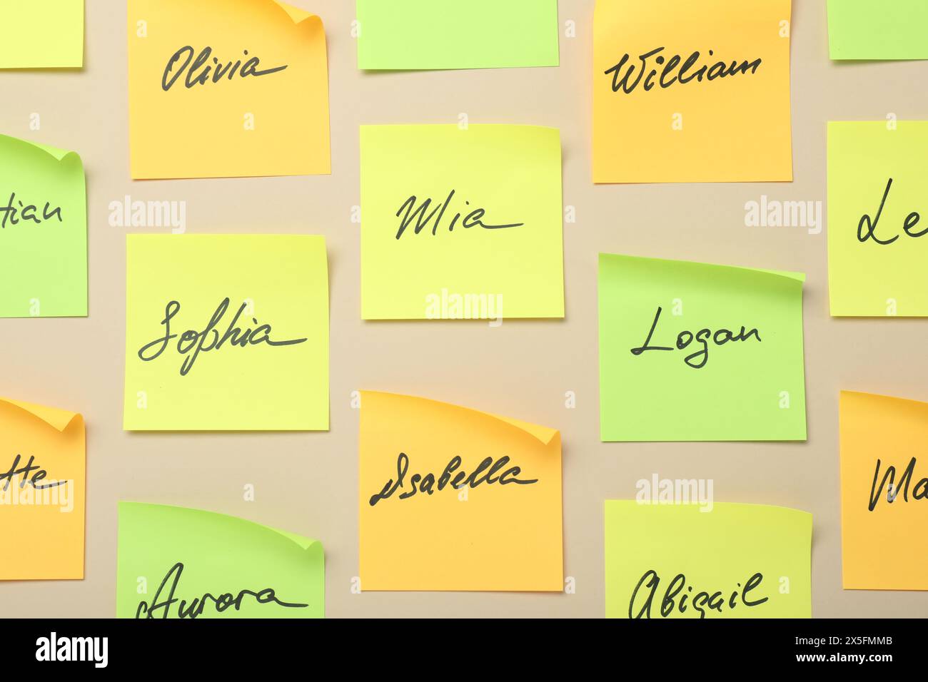 Paper stickers with different names on beige background, flat lay ...
