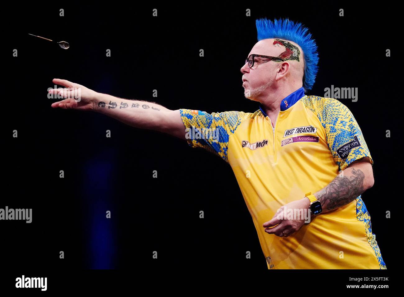 Peter Wright in action against Luke Littler (not pictured) during night ...
