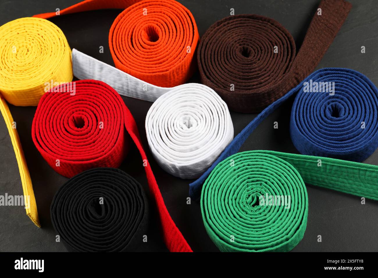 Colorful karate belts on gray background, above view Stock Photo - Alamy