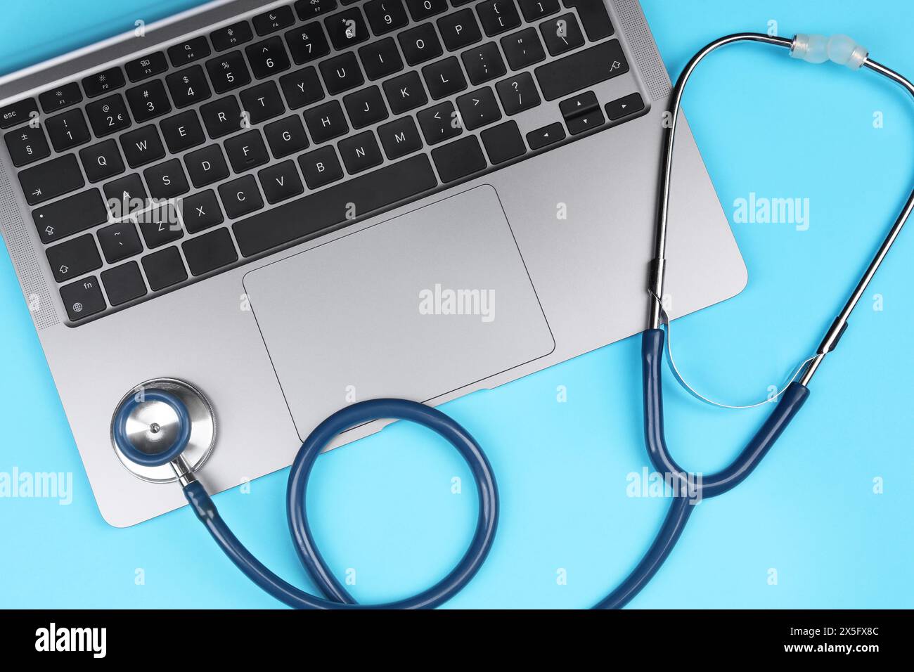 Laptop and stethoscope on light blue background, flat lay Stock Photo ...