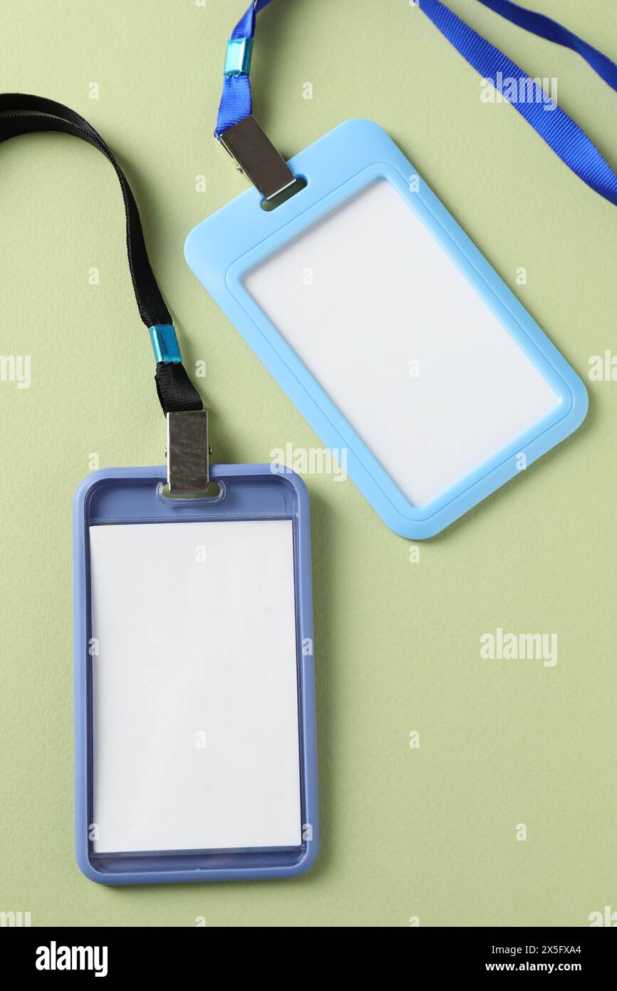 Blank badges with strings on light green background, top view Stock ...