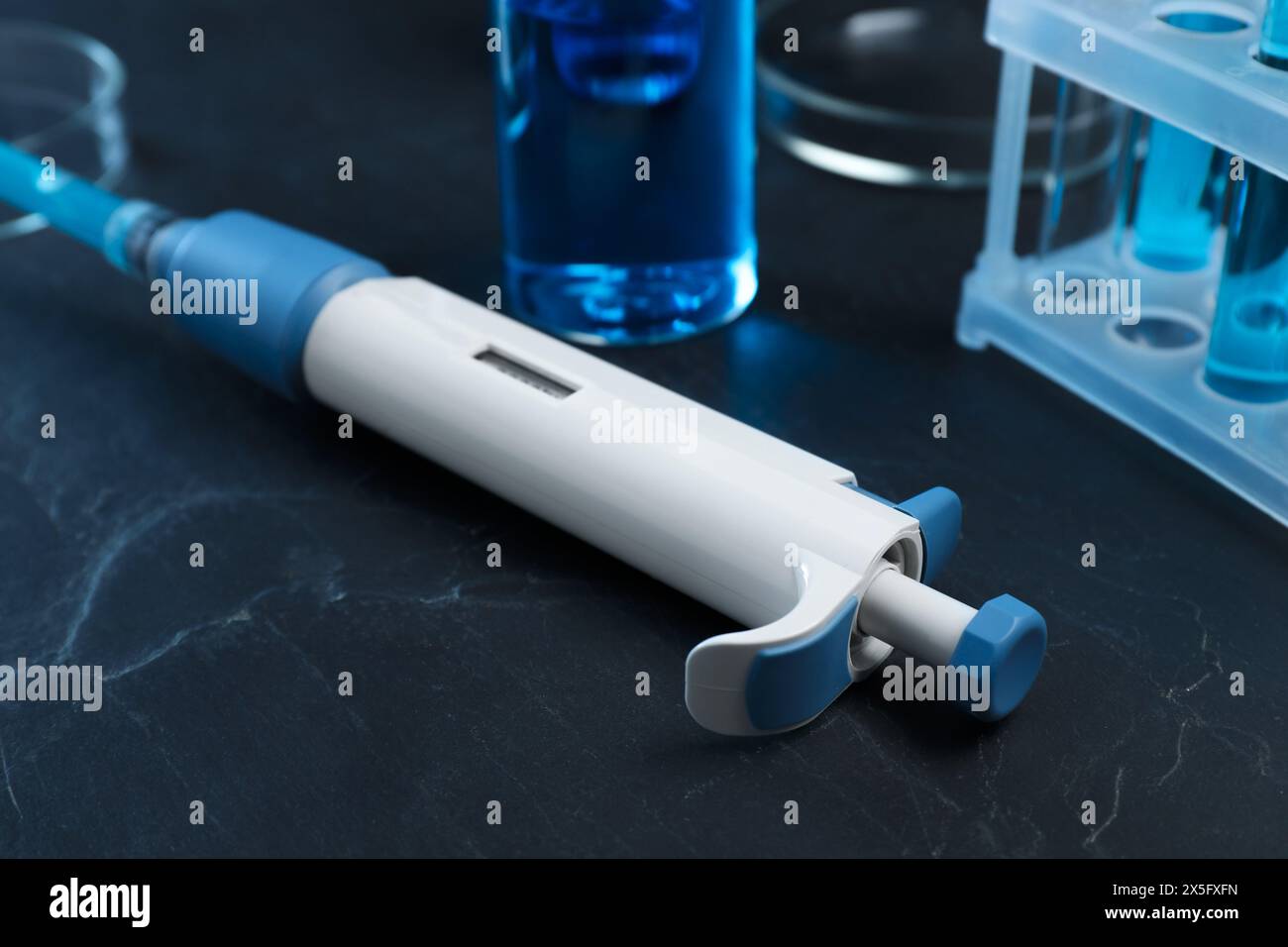 Laboratory analysis. Micropipette on black table, closeup Stock Photo ...