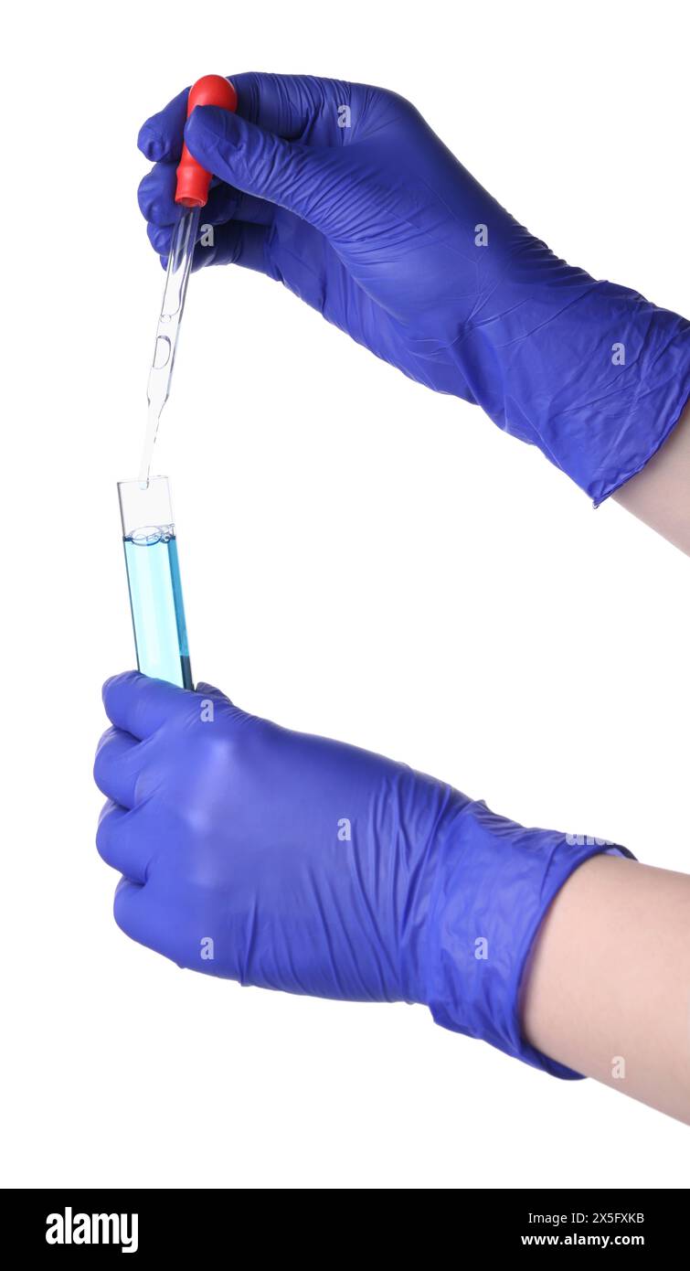 Scientist dripping liquid from pipette into test tube on white ...