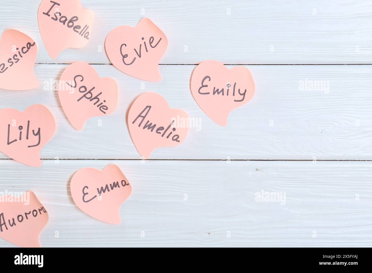 Choosing baby's name. Paper stickers with different names on white ...
