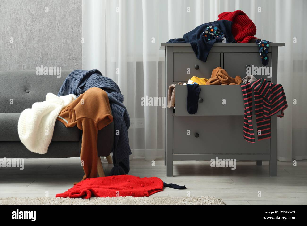 Room and dresser cluttered with clothes. Messy house Stock Photo - Alamy