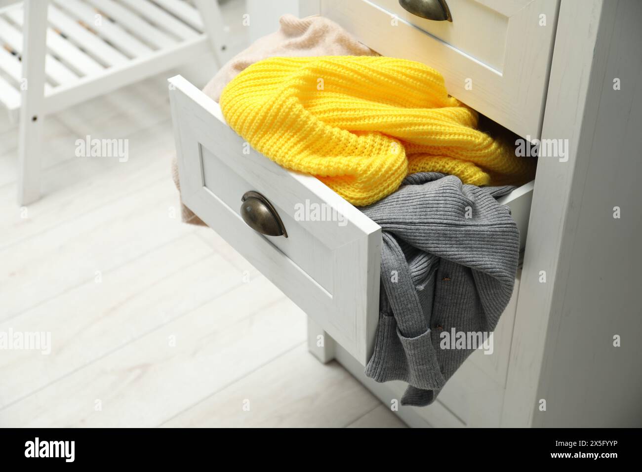 Cluttered chest of drawers indoors. Clothes in mess Stock Photo - Alamy