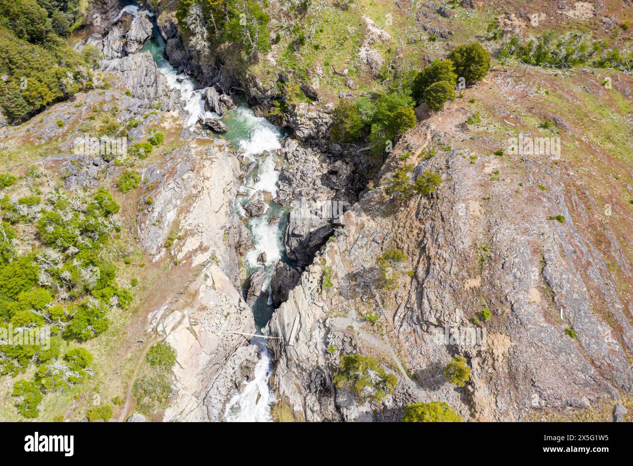 Aerial view of waterfall Mellizo south of Cochrane, hiking path and ...