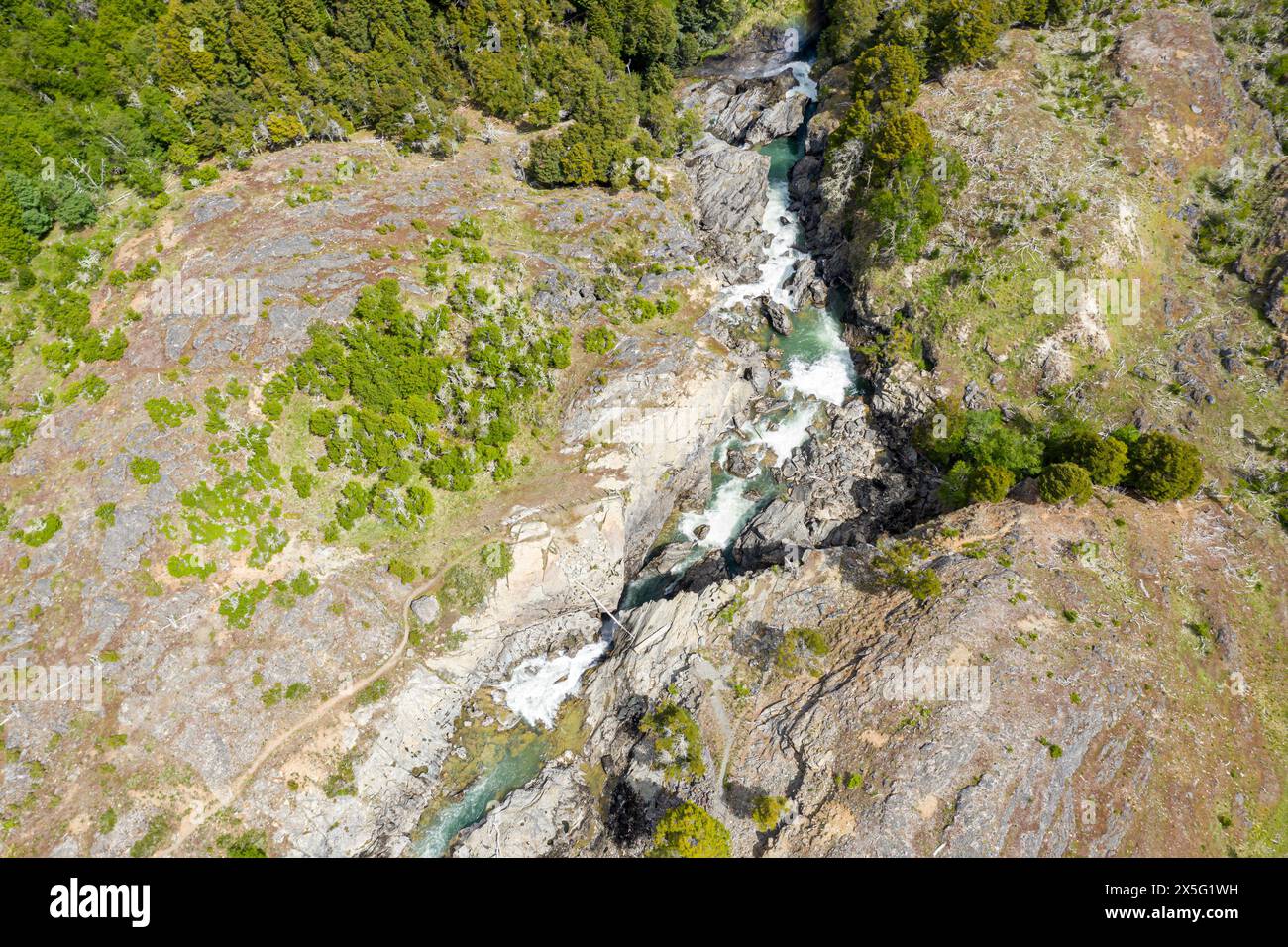 Aerial view of waterfall Mellizo south of Cochrane, hiking path and ...