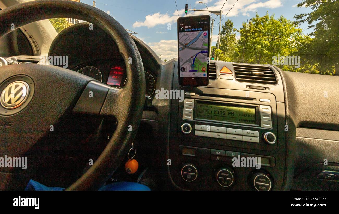 Smartphone showing Waze maps to show the way thru the city. Driver ...