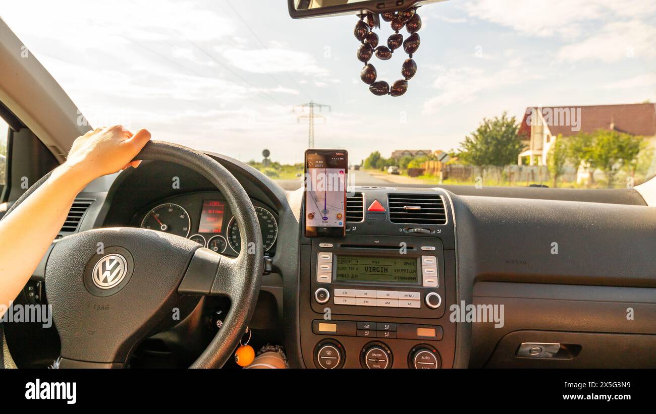 Smartphone showing Waze maps to show the way thru the city. Driver ...