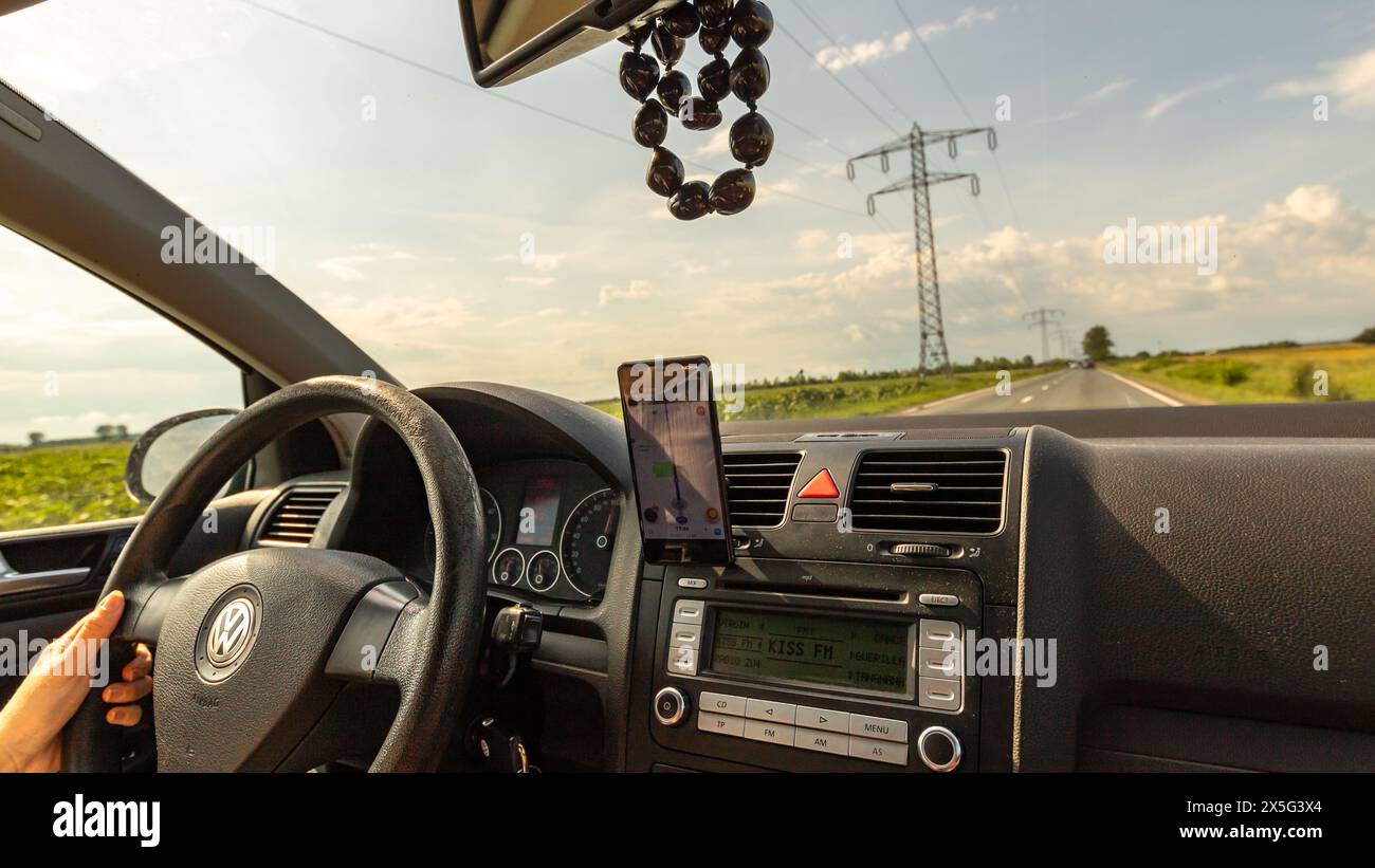 Smartphone showing Waze maps to show the way thru the city. Driver ...