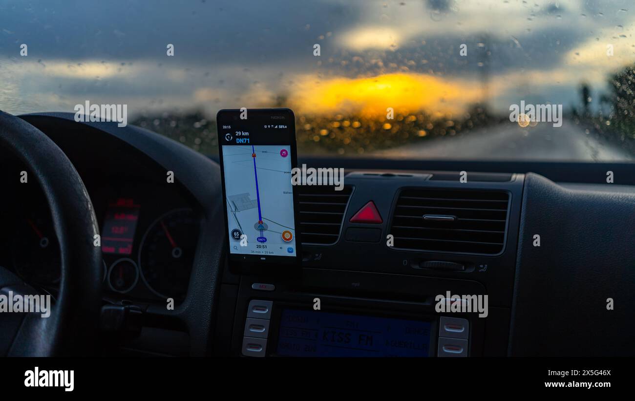 Smartphone showing Waze maps to show the way thru the city. Driver ...