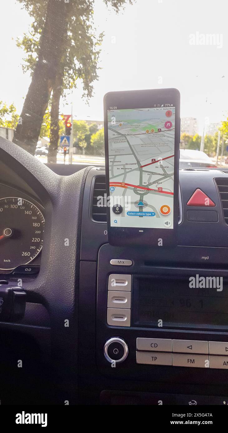Smartphone showing Waze maps to show the way thru the city. Driver ...